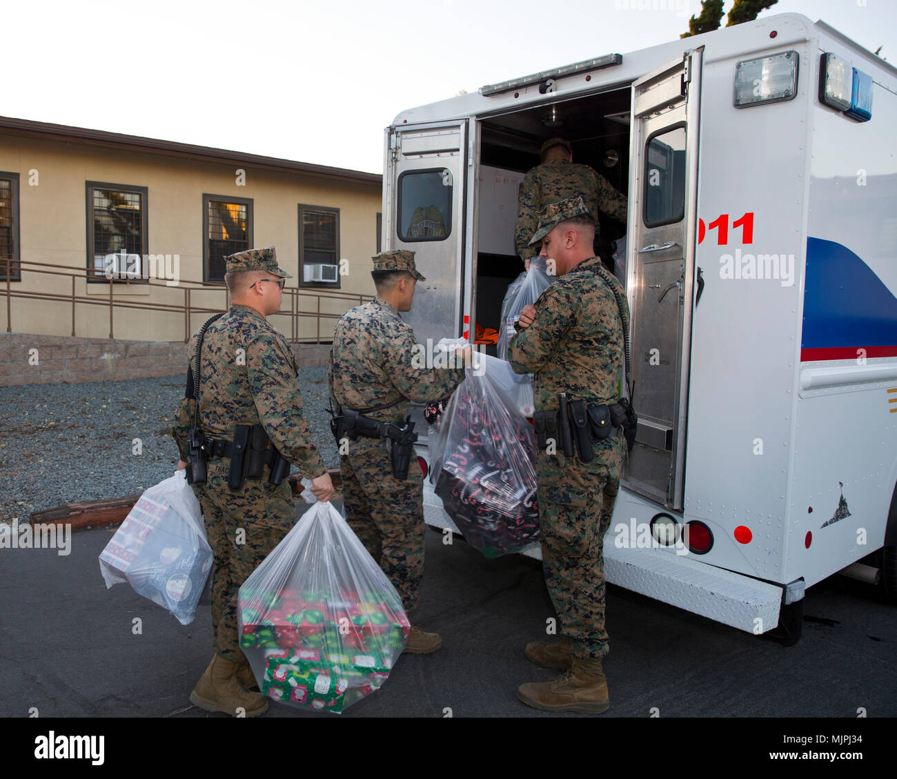 Marines and police officers with the Provost Marshal’s Office, deliver ...