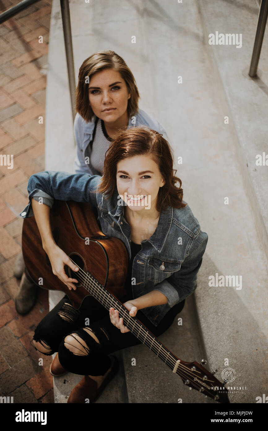 Cute Young Female Musicians Girl Friends Laughing and Singing on Urban ...
