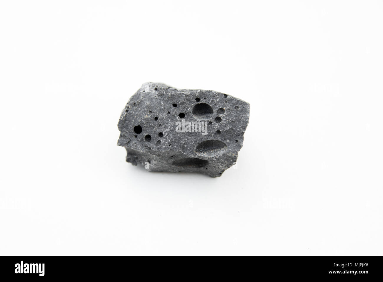 extreme close up with a lot of details of basalt rock isolated over ...