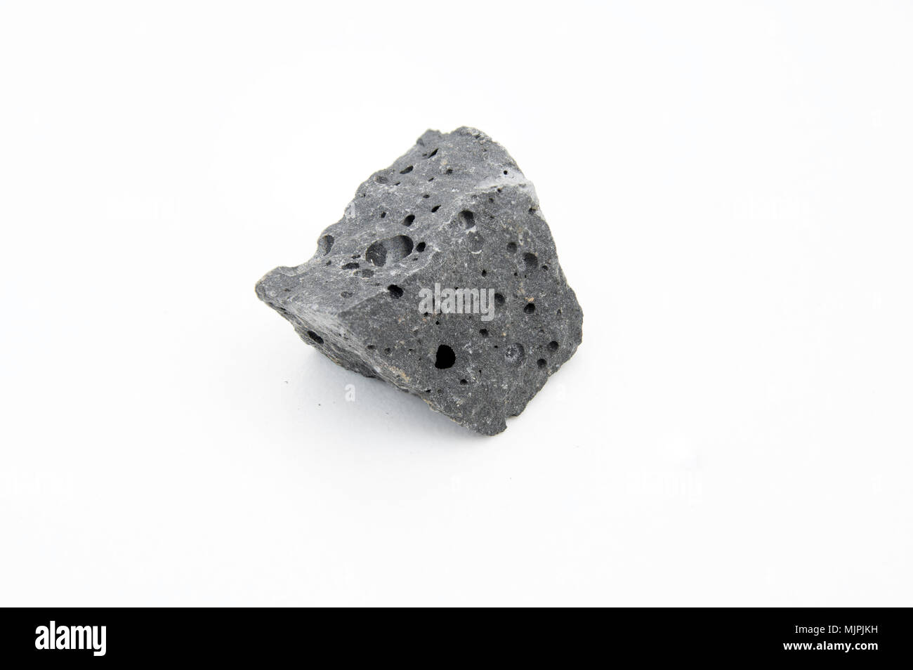 extreme close up with a lot of details of basalt rock isolated over ...