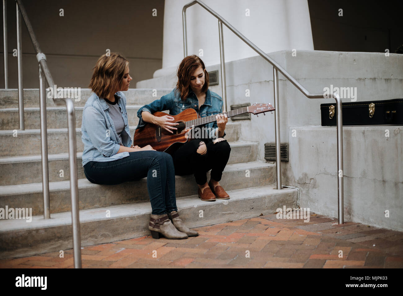 Cute Young Female Musicians Girl Friends Laughing and Singing on Urban ...