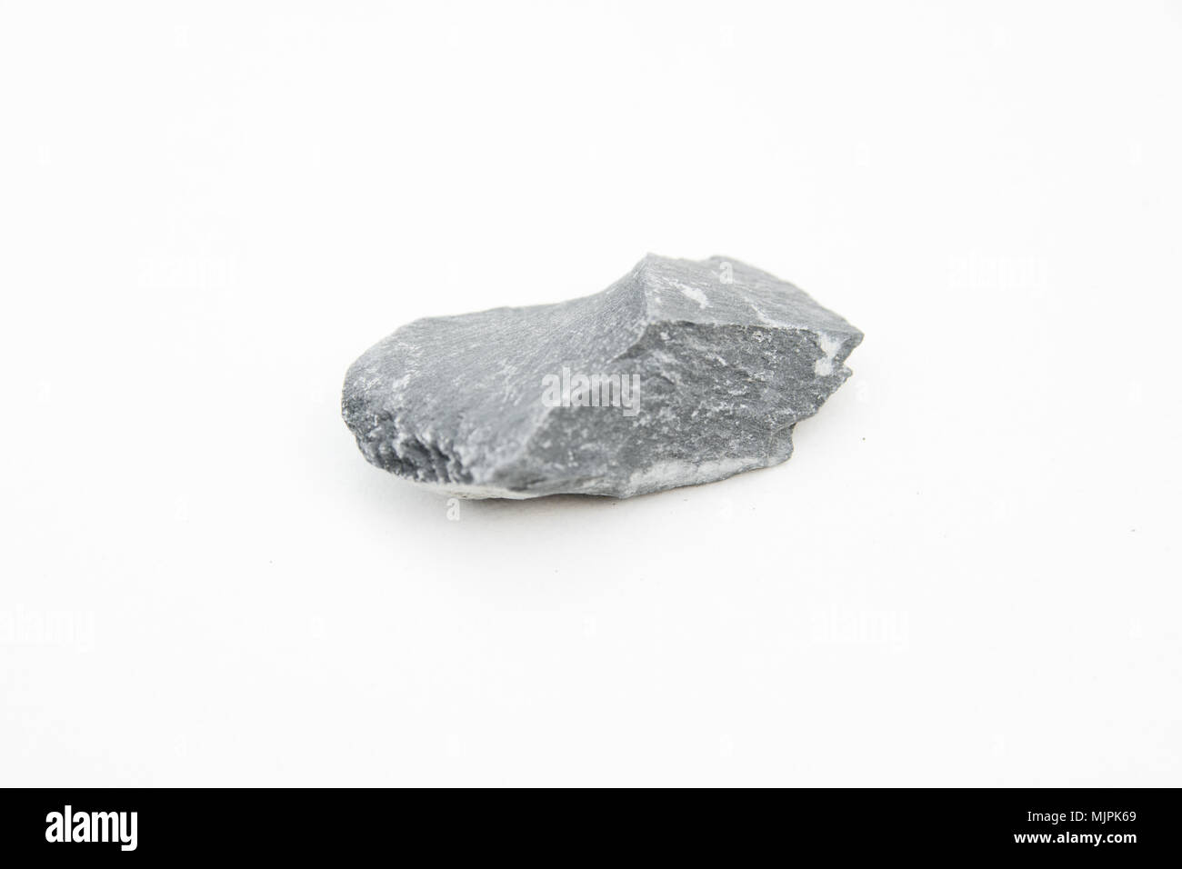 extreme close up with a lot of details of mudstone isolated over white ...