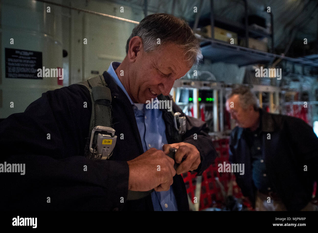 Tim Coombs, 23d Maintenance Group Honorary Commander, adjusts his ...
