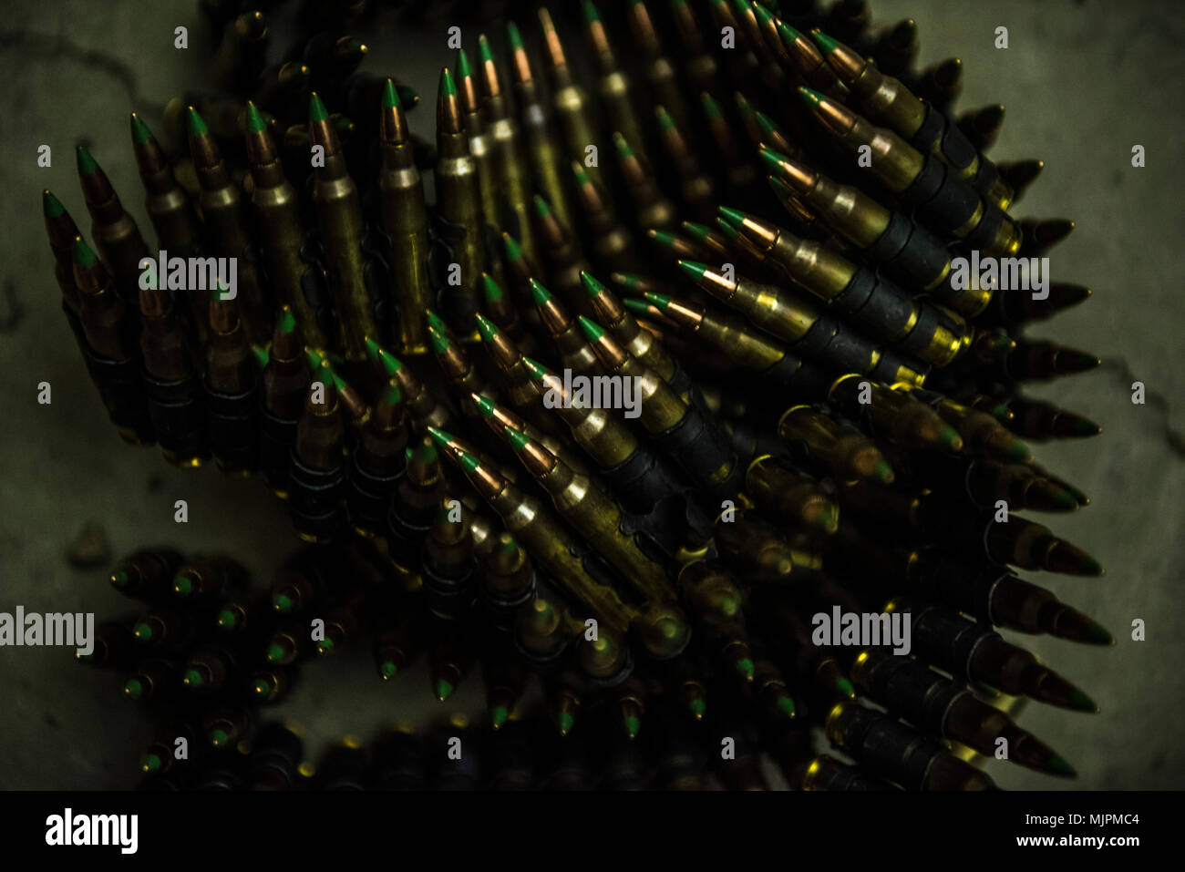 A pile of 7.62 millimeter rounds lays on the ground during weapons ...