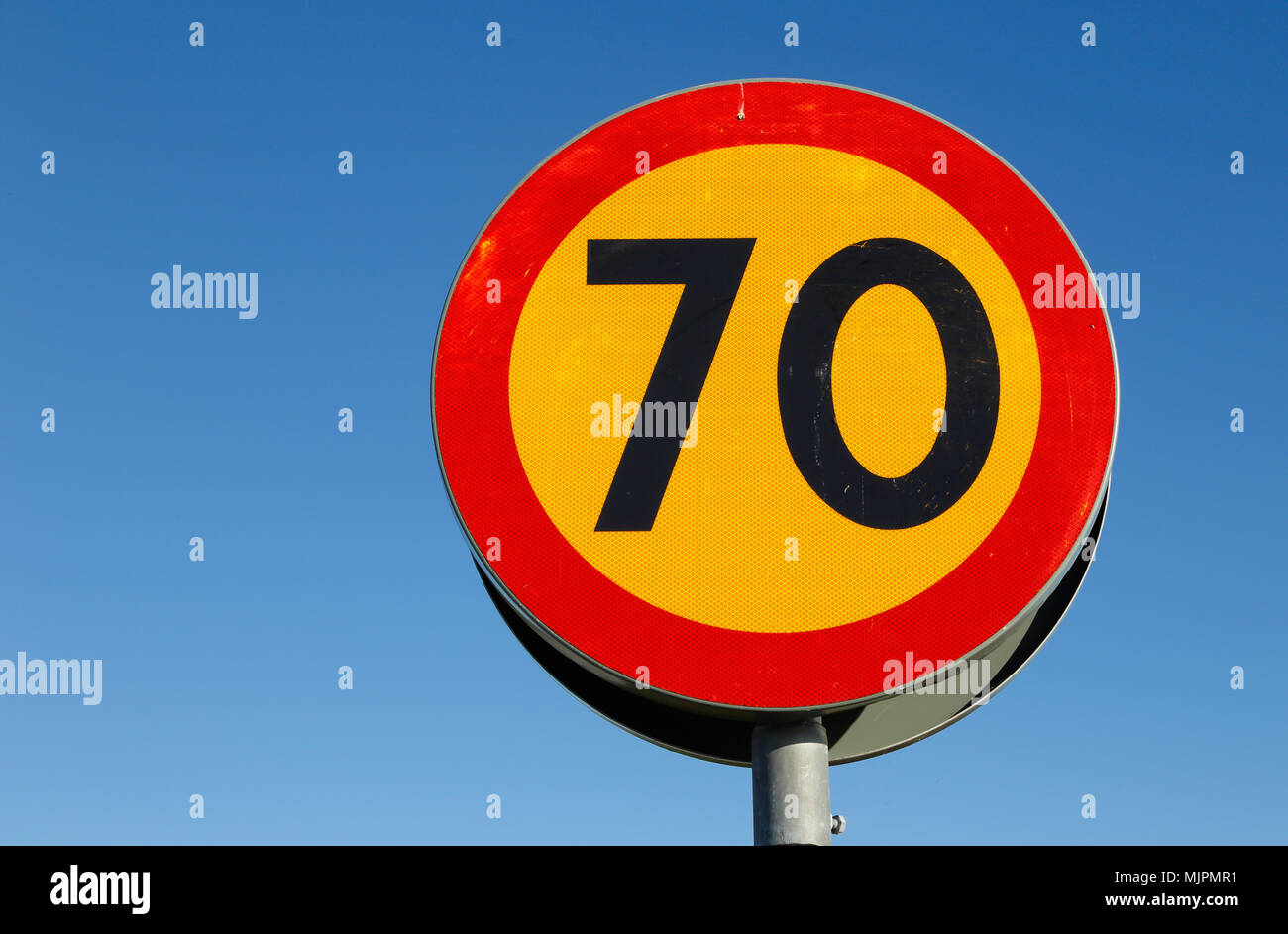 Sweddish speed limit sign 70 on blue sky Stock Photo - Alamy