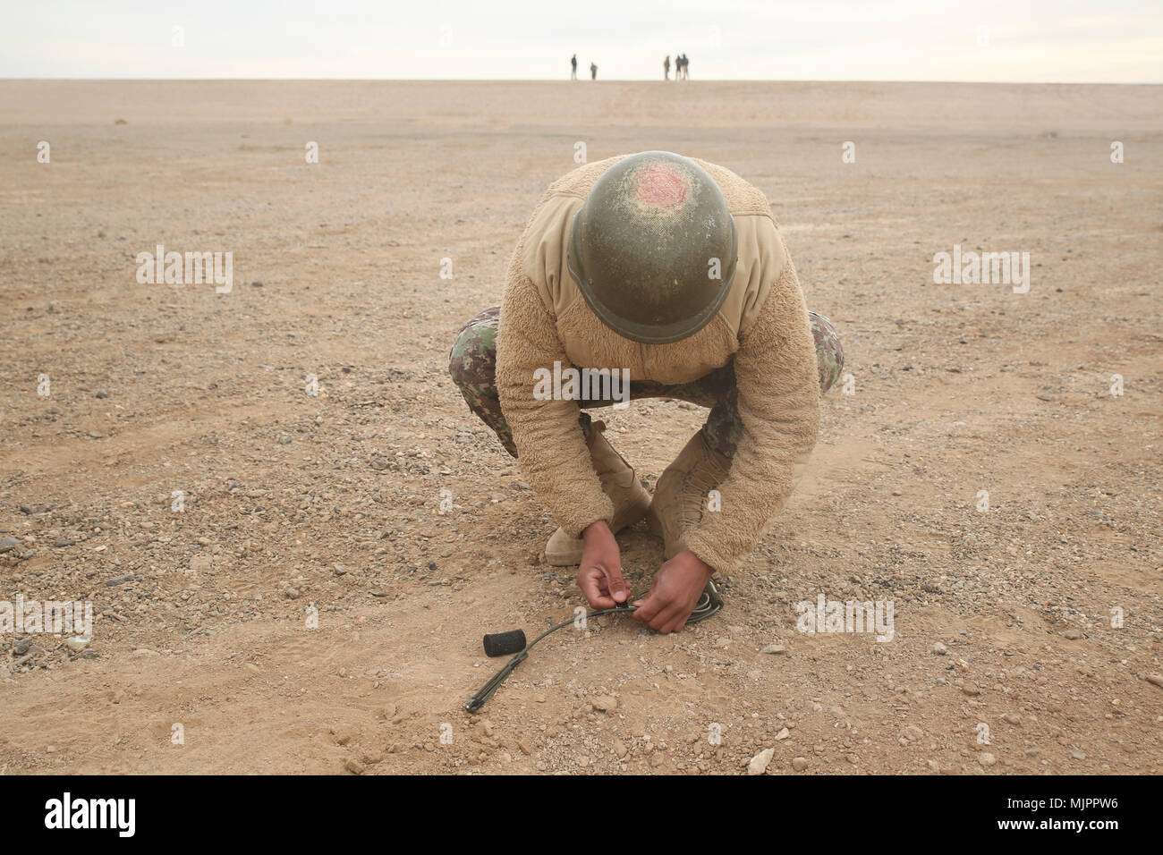 An Afghan National Army soldier with 215th Corps prepares to tie a ...