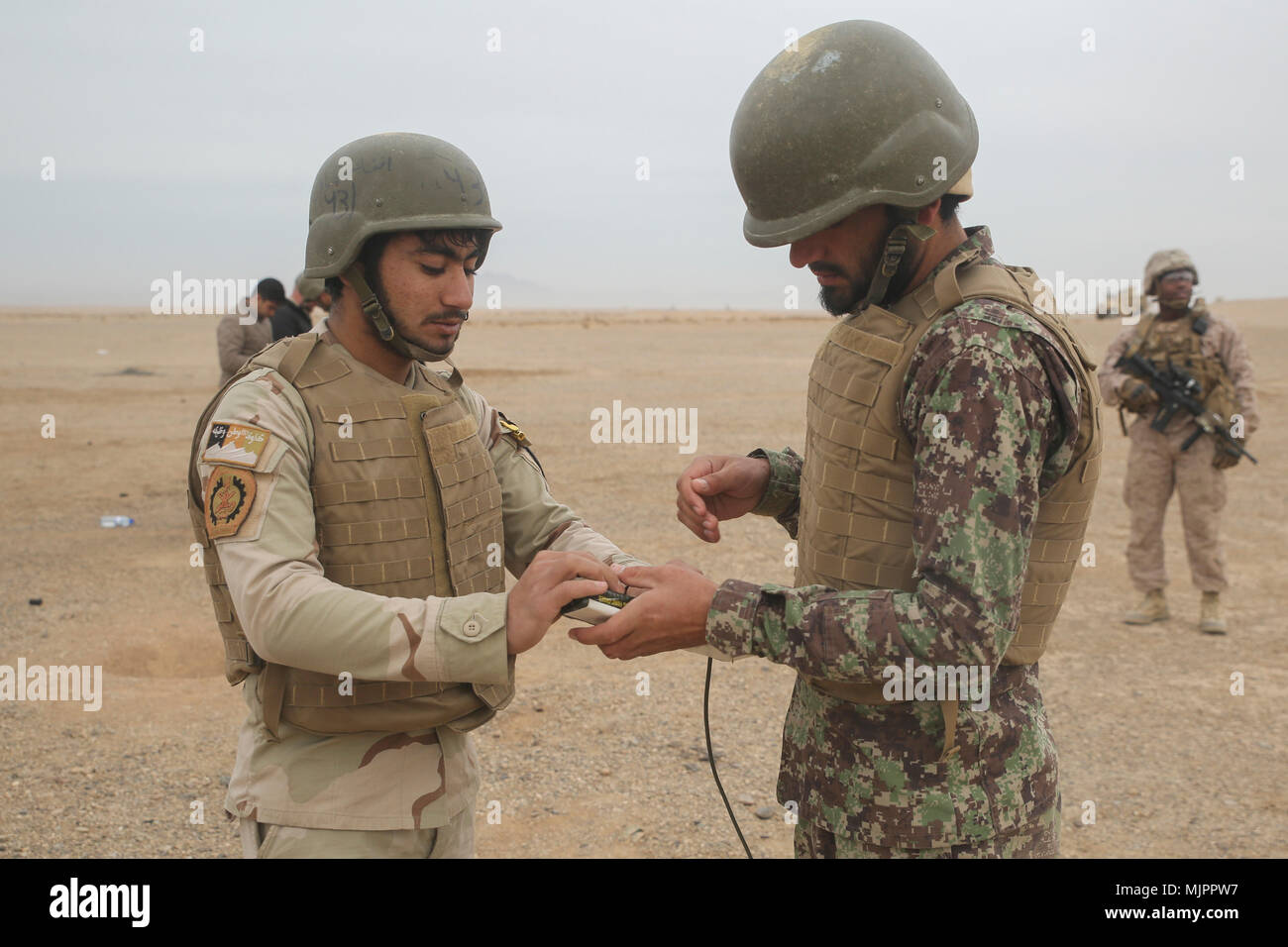 Afghan National Army soldiers with 215th Corps tie a demolition charge ...