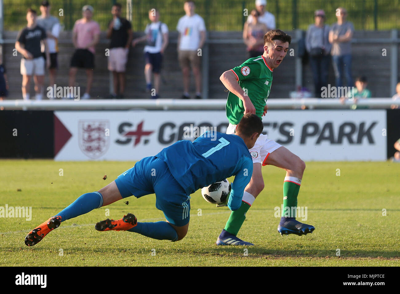 Nick Shinton of Belgium saves at the feet of Barry Coffey of the ...