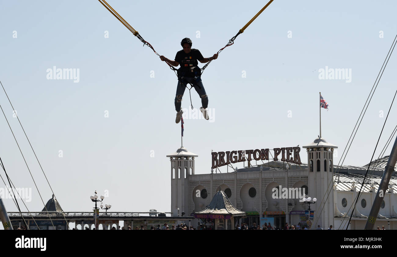Brighton UK 6th May 2018 - Visitors enjoy the hot sunny weather alone g ...