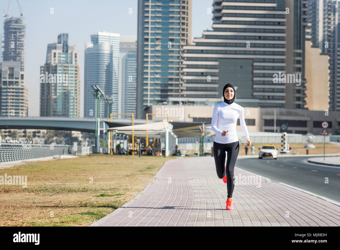 Arabic woman running outdoor and wearing hijab Stock Photo - Alamy