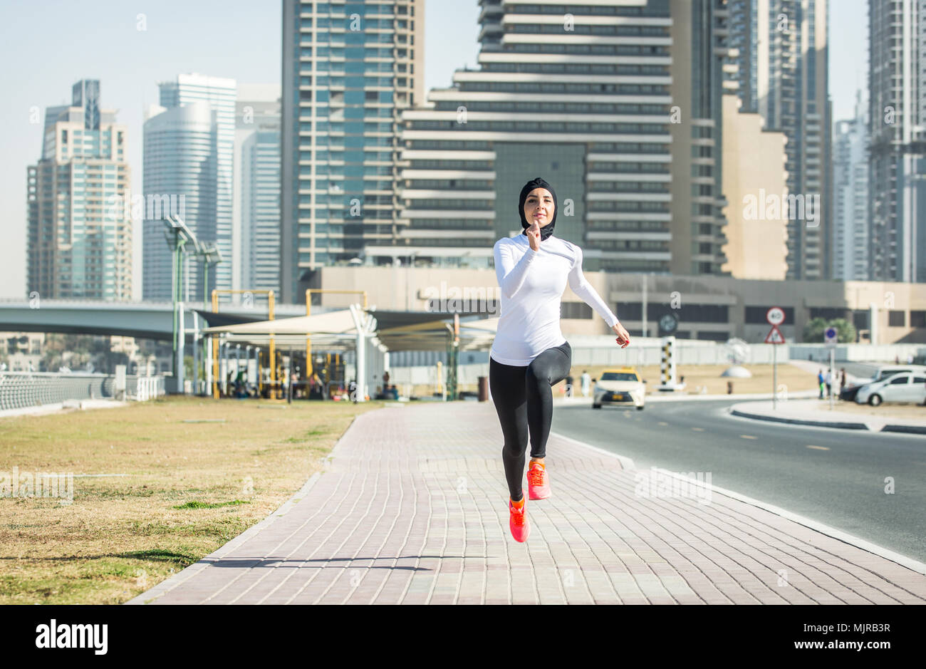 Arabic woman running outdoor and wearing hijab Stock Photo - Alamy