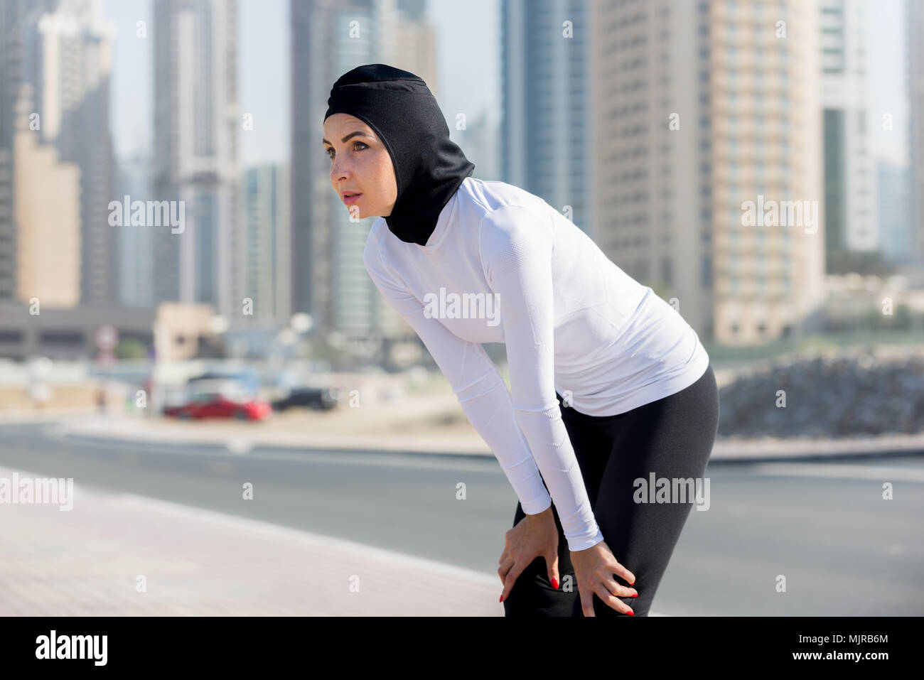 Arabic woman running outdoor and wearing hijab Stock Photo - Alamy