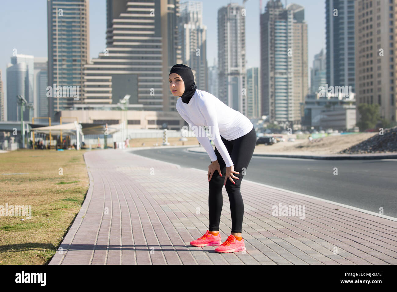 Arabic woman running outdoor and wearing hijab Stock Photo - Alamy