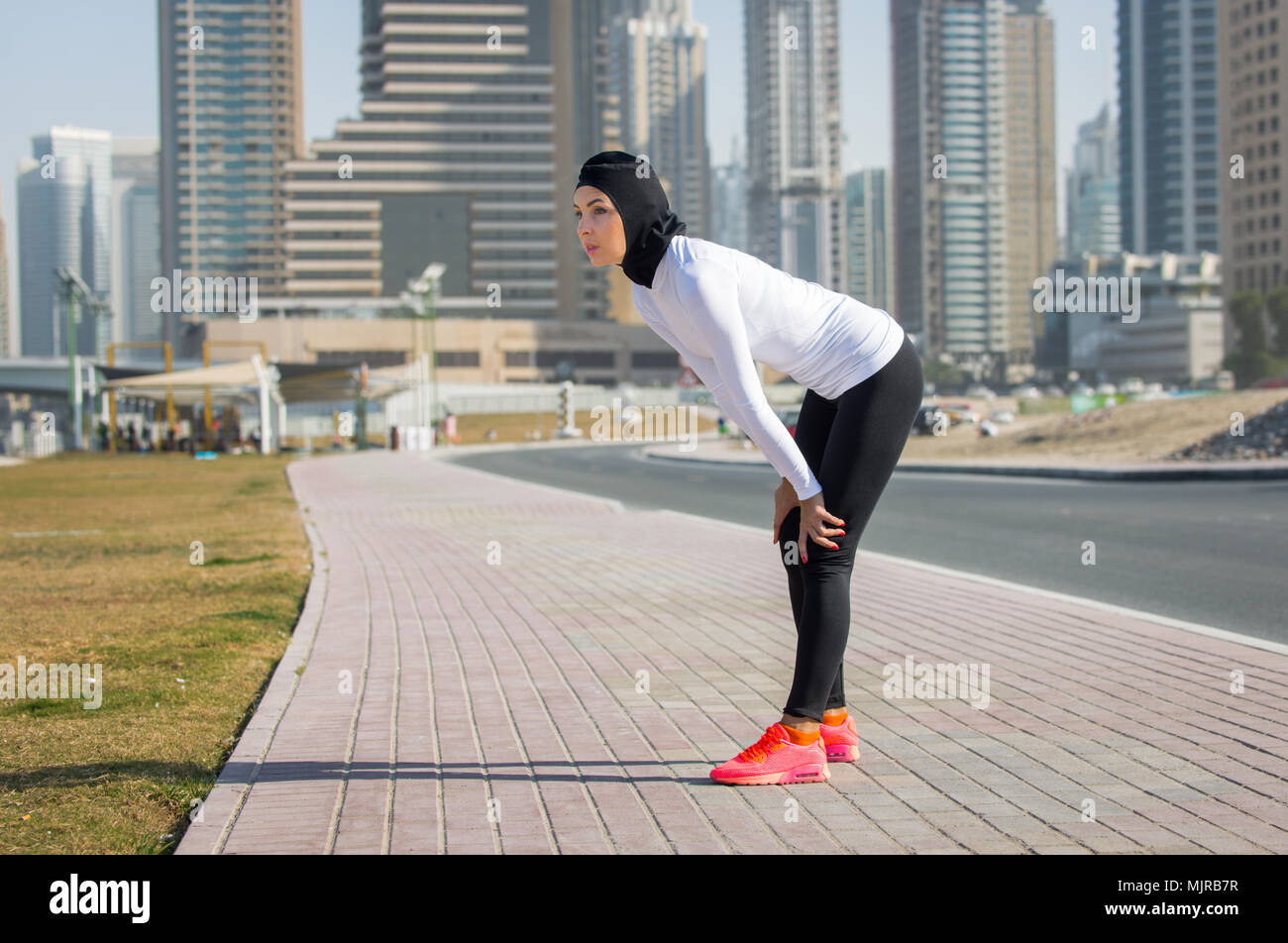 Arabic woman running outdoor and wearing hijab Stock Photo - Alamy