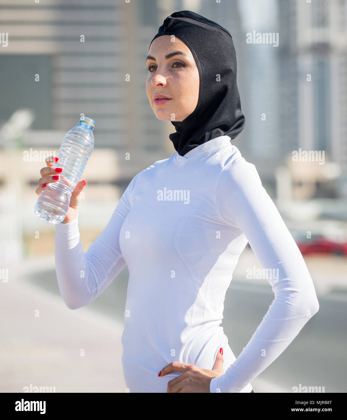 Arabic woman running outdoor and wearing hijab Stock Photo - Alamy