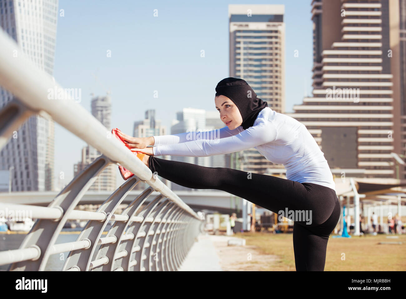 Arabic woman running outdoor and wearing hijab Stock Photo - Alamy