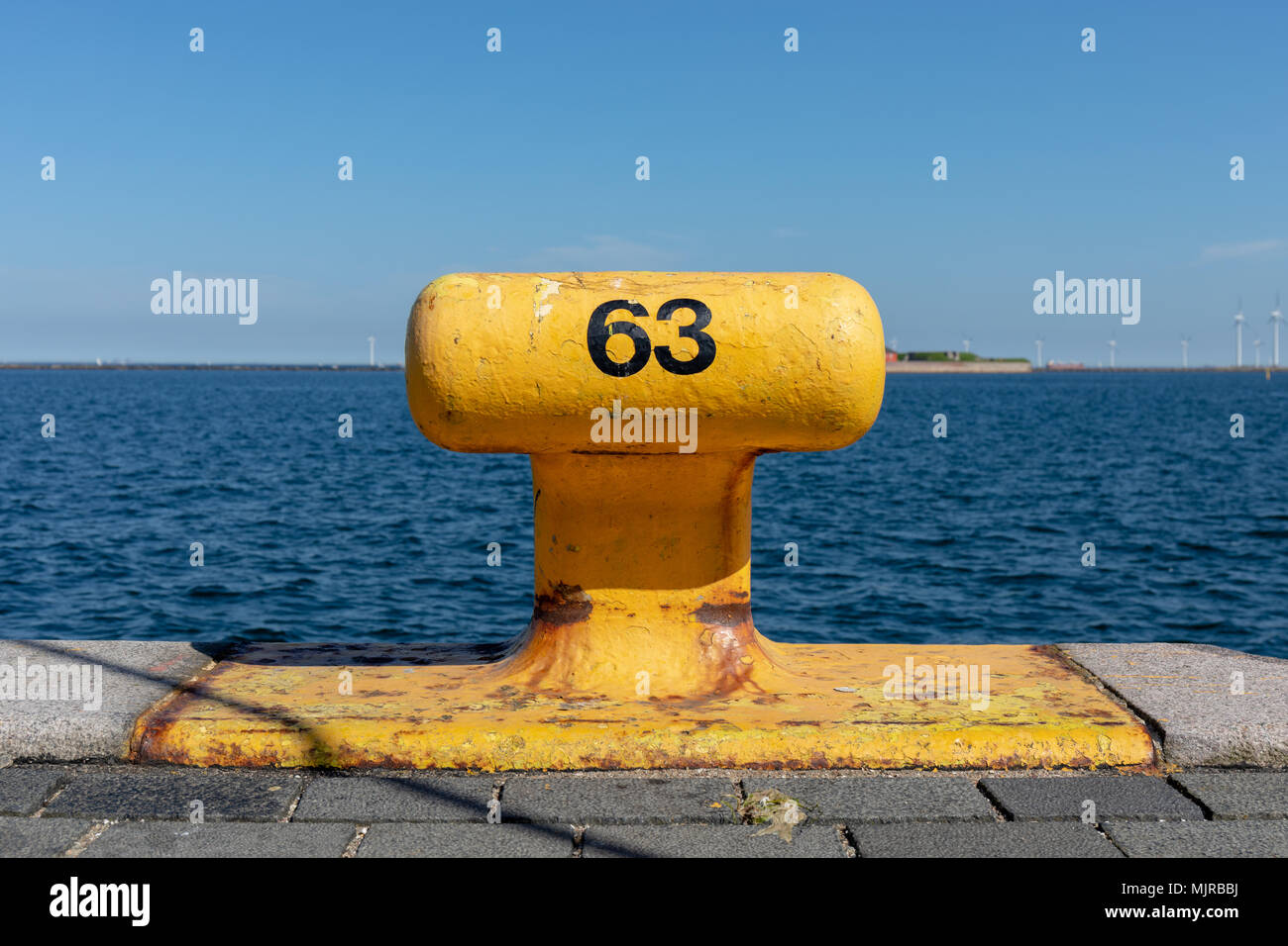 Yellow bollard with the number 63; Langelinie, Copenhagen, Denmark ...