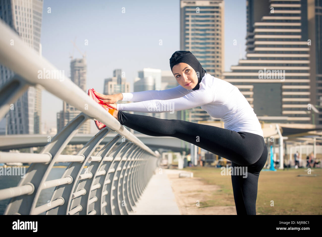 Arabic woman running outdoor and wearing hijab Stock Photo - Alamy