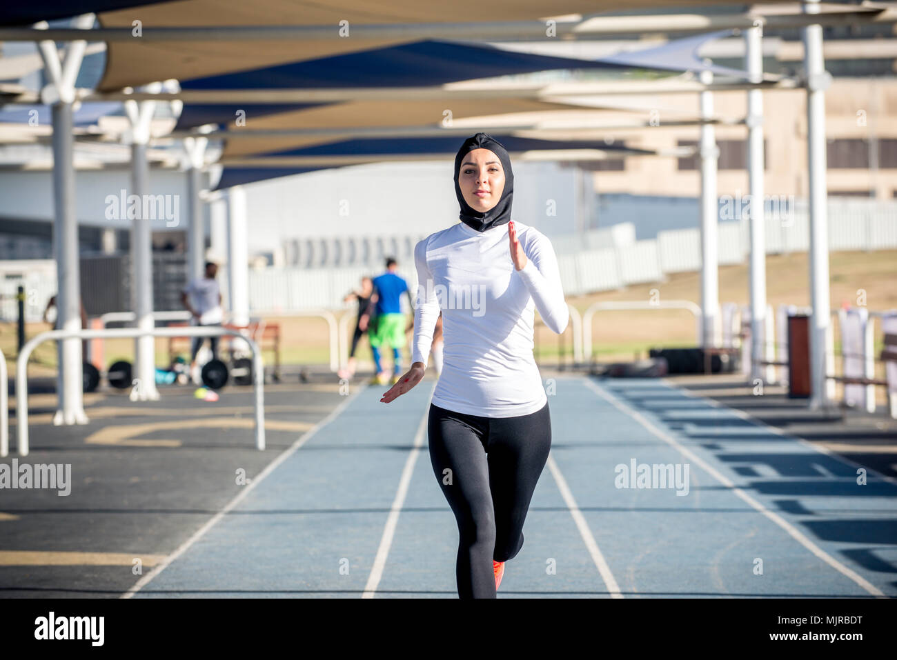 Arabic woman running outdoor and wearing hijab Stock Photo - Alamy