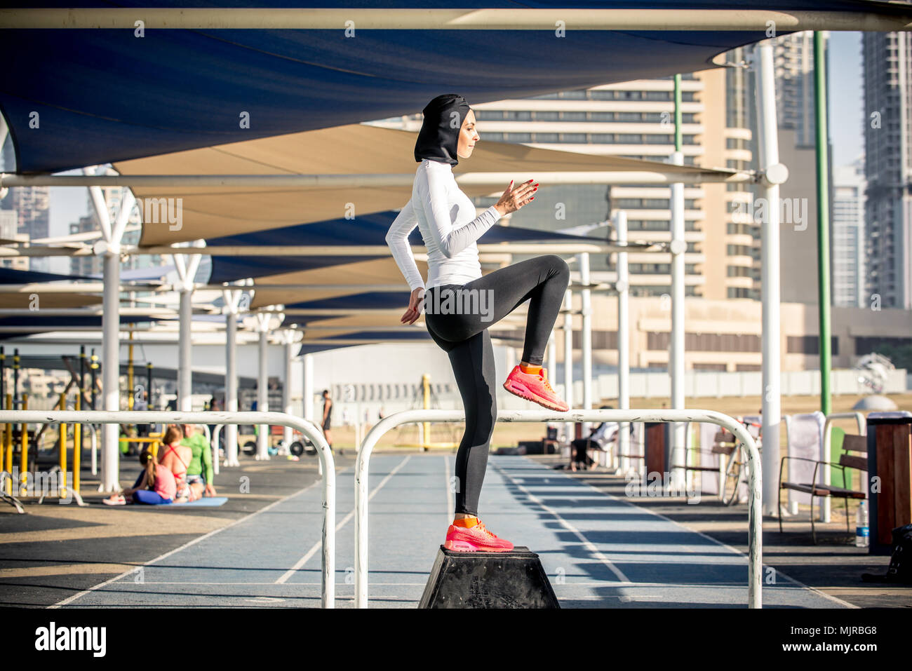 Arabic woman running outdoor and wearing hijab Stock Photo - Alamy