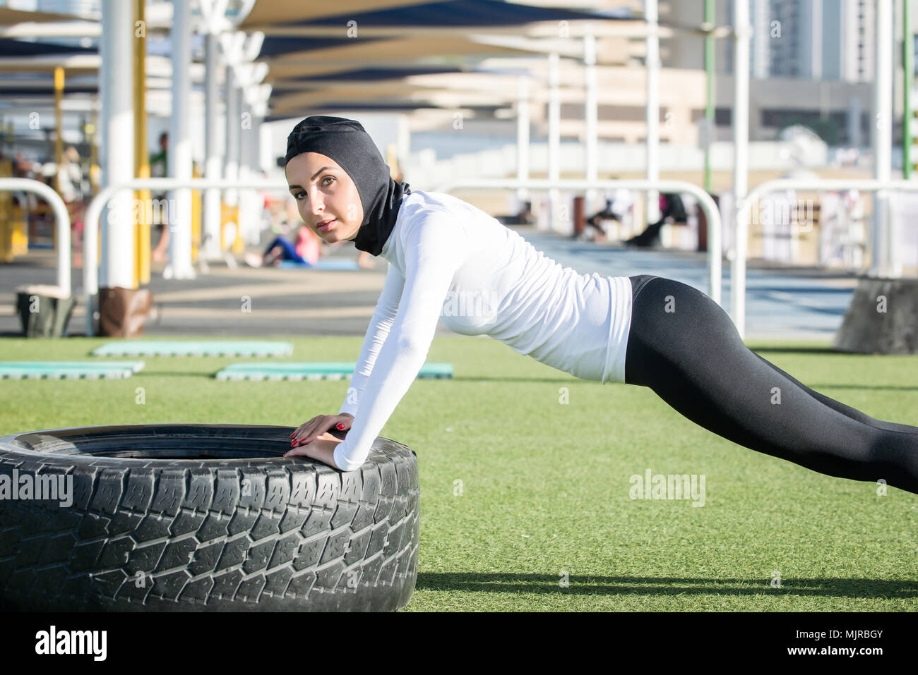 Arabic woman running outdoor and wearing hijab Stock Photo - Alamy