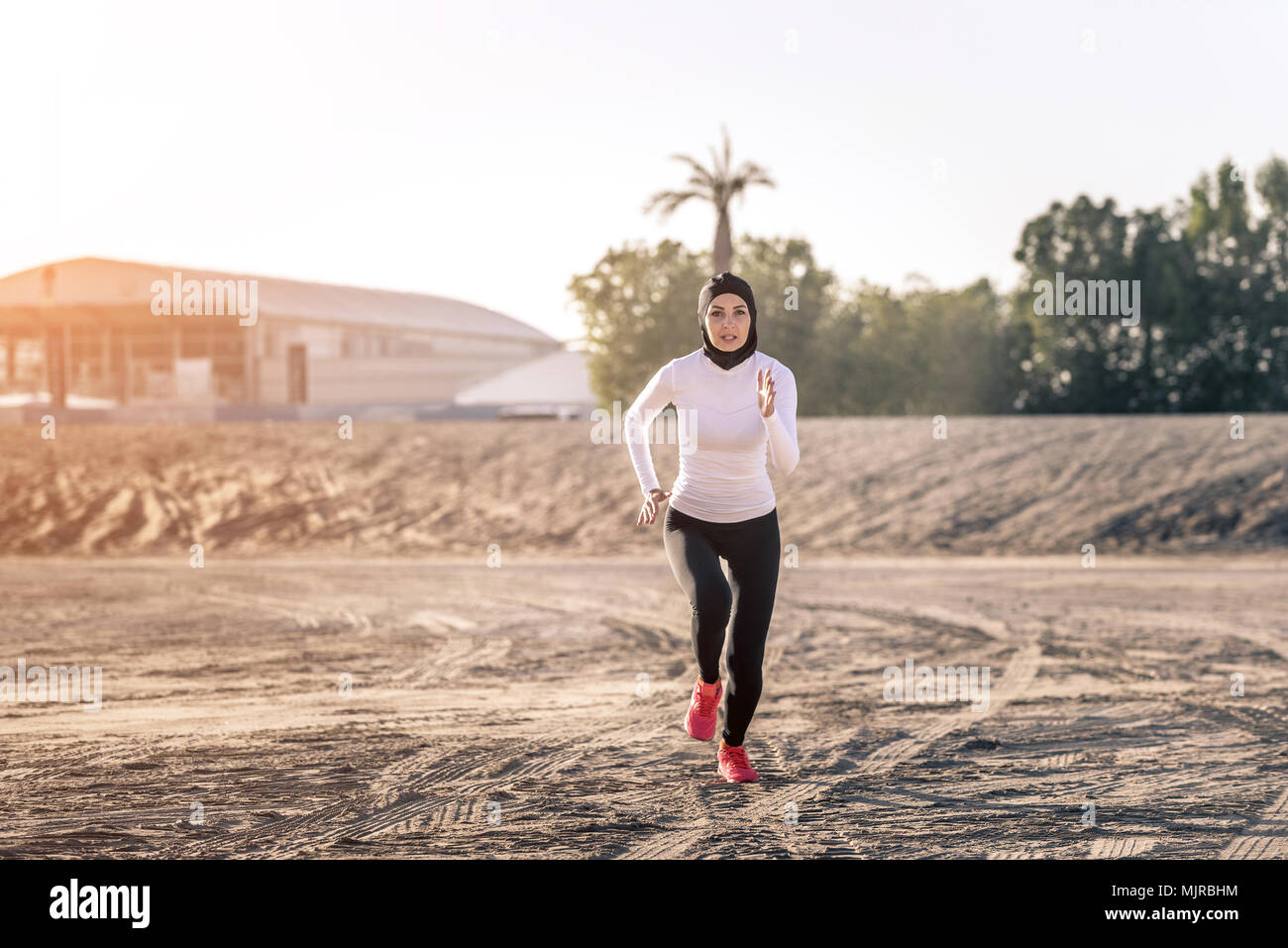 Arabic woman running outdoor and wearing hijab Stock Photo - Alamy