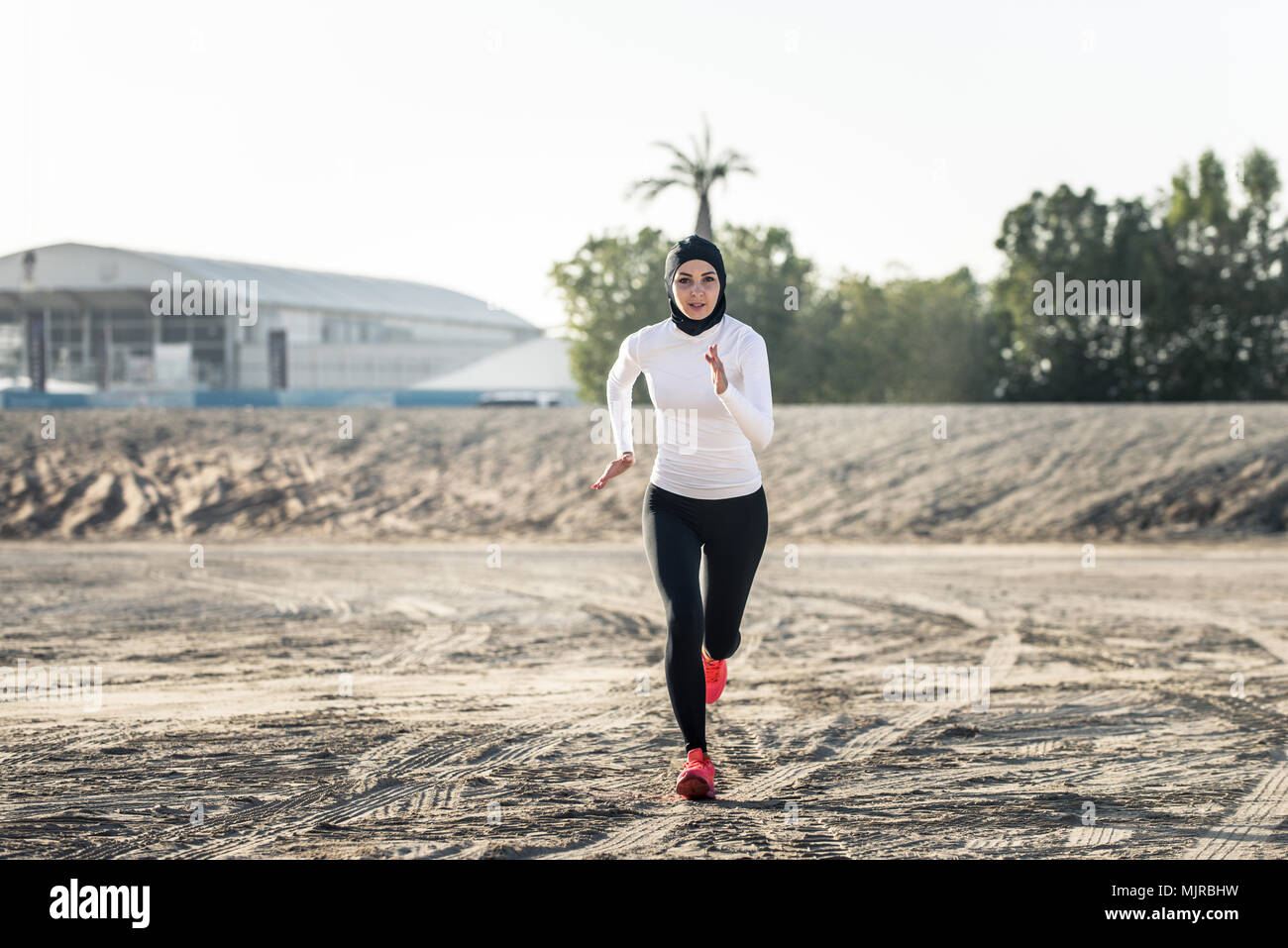 Arabic woman running outdoor and wearing hijab Stock Photo - Alamy