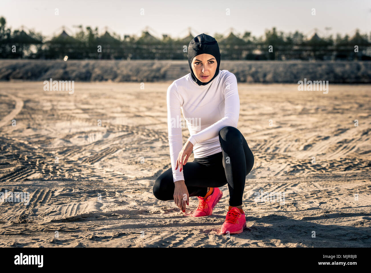 Arabic woman running outdoor and wearing hijab Stock Photo - Alamy