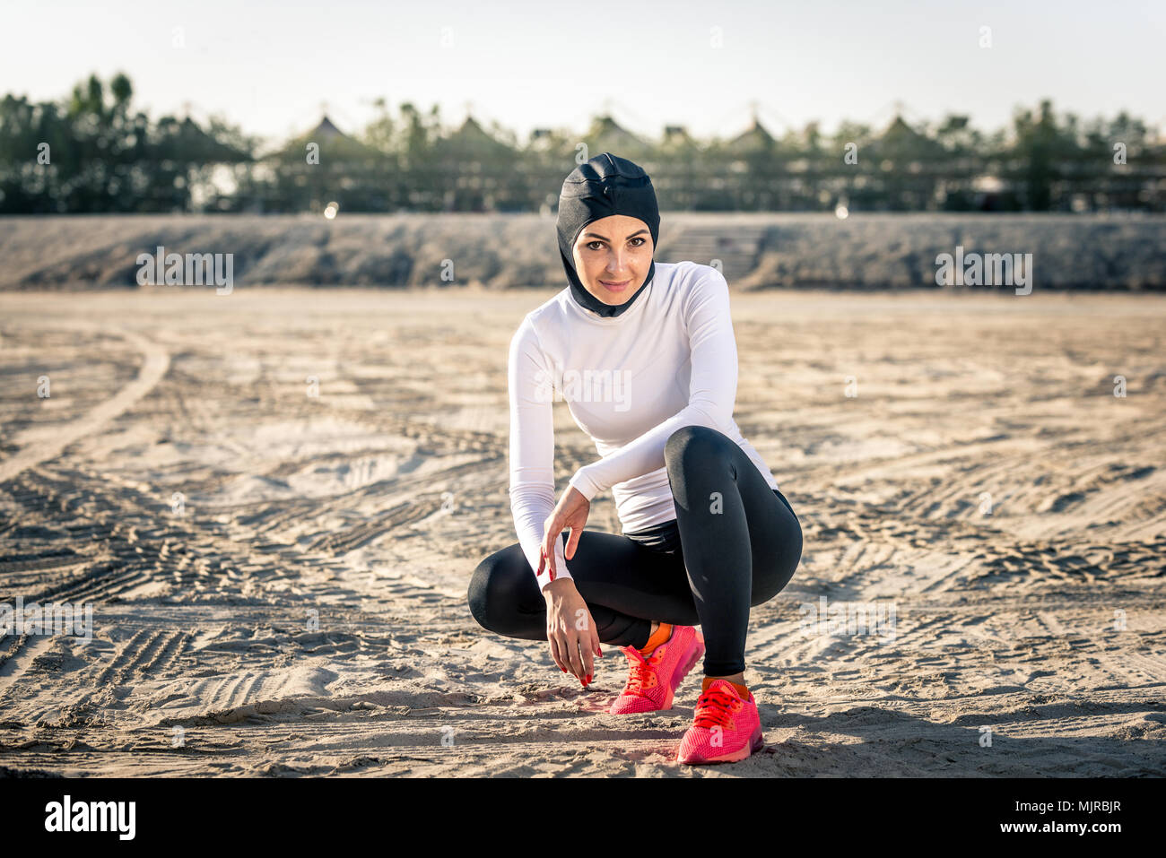 Arabic woman running outdoor and wearing hijab Stock Photo - Alamy