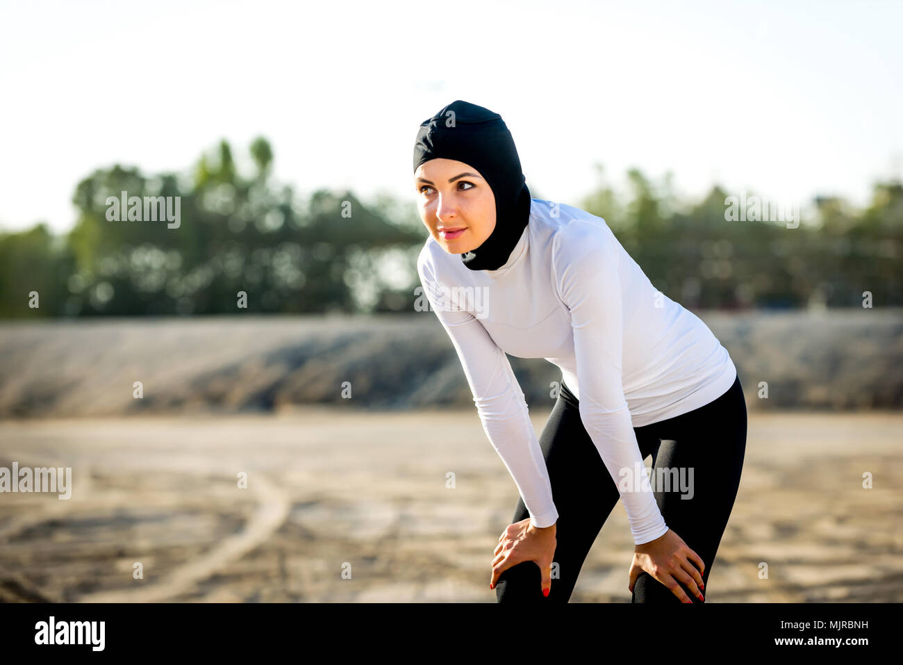 Arabic woman running outdoor and wearing hijab Stock Photo - Alamy