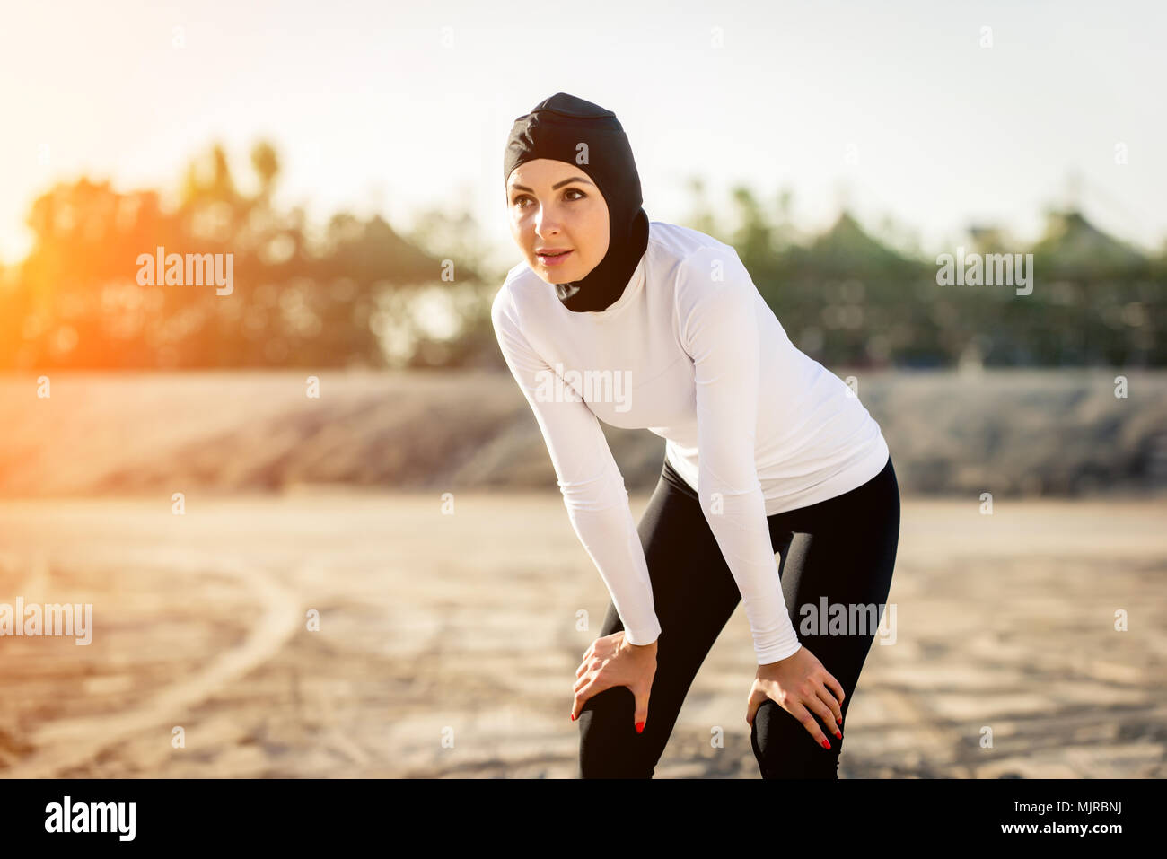 Arabic woman running outdoor and wearing hijab Stock Photo - Alamy