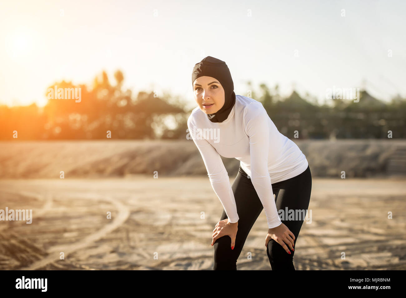 Arabic woman running outdoor and wearing hijab Stock Photo - Alamy