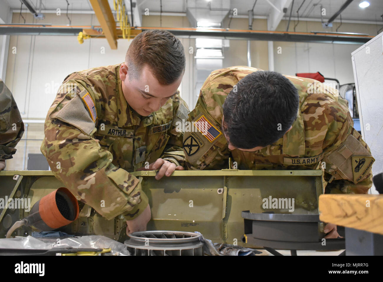 Spc. Brandon Arthur, left, and Staff Sgt. Javier Fuentes, assigned to ...