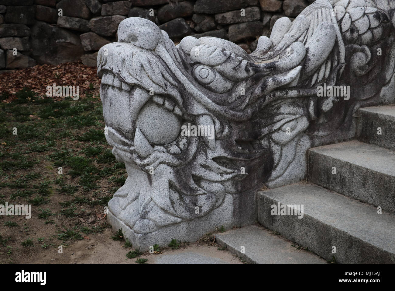 A huge dragon carved in stone, with an orb or yeouiju, in its mouth ...