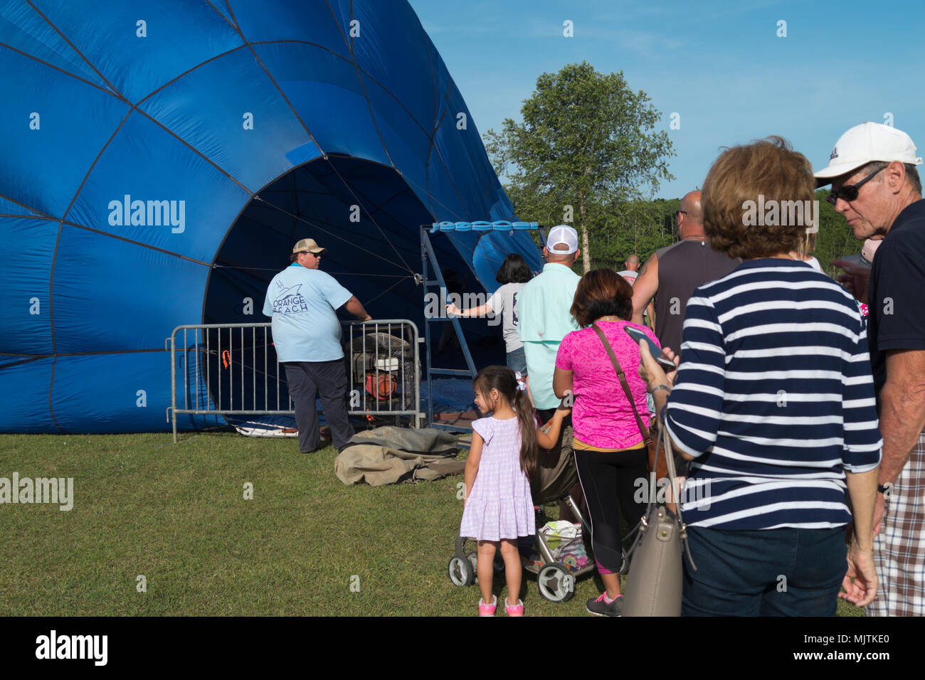People lined up to walk inside a partially inflated hot air balloon at ...