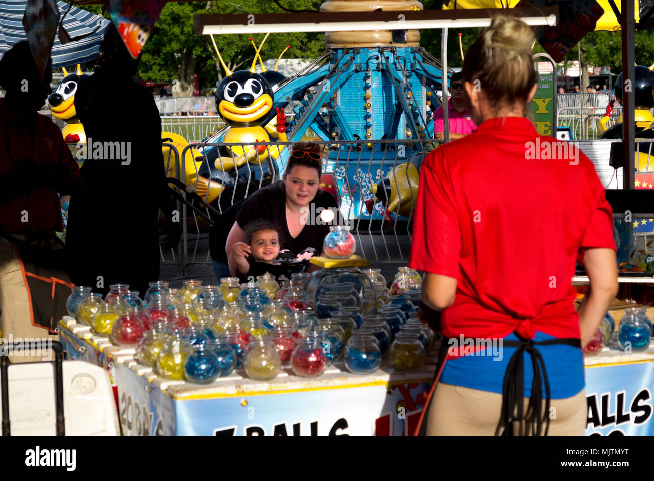 Little girl tosses a ball to win a prize at the 14th annual Hot Air ...