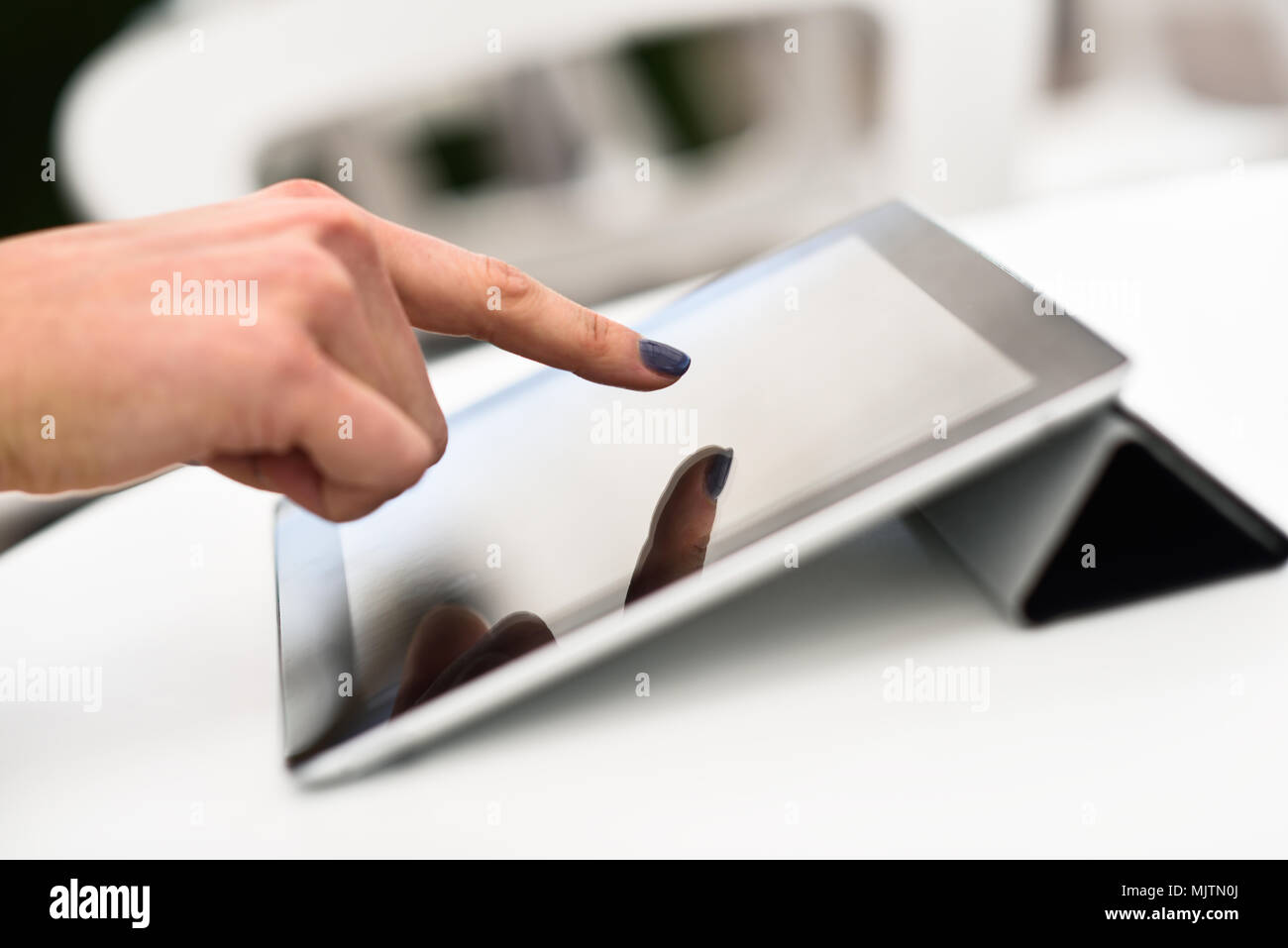 Close-up of a woman's hand touching a tablet computer Stock Photo - Alamy