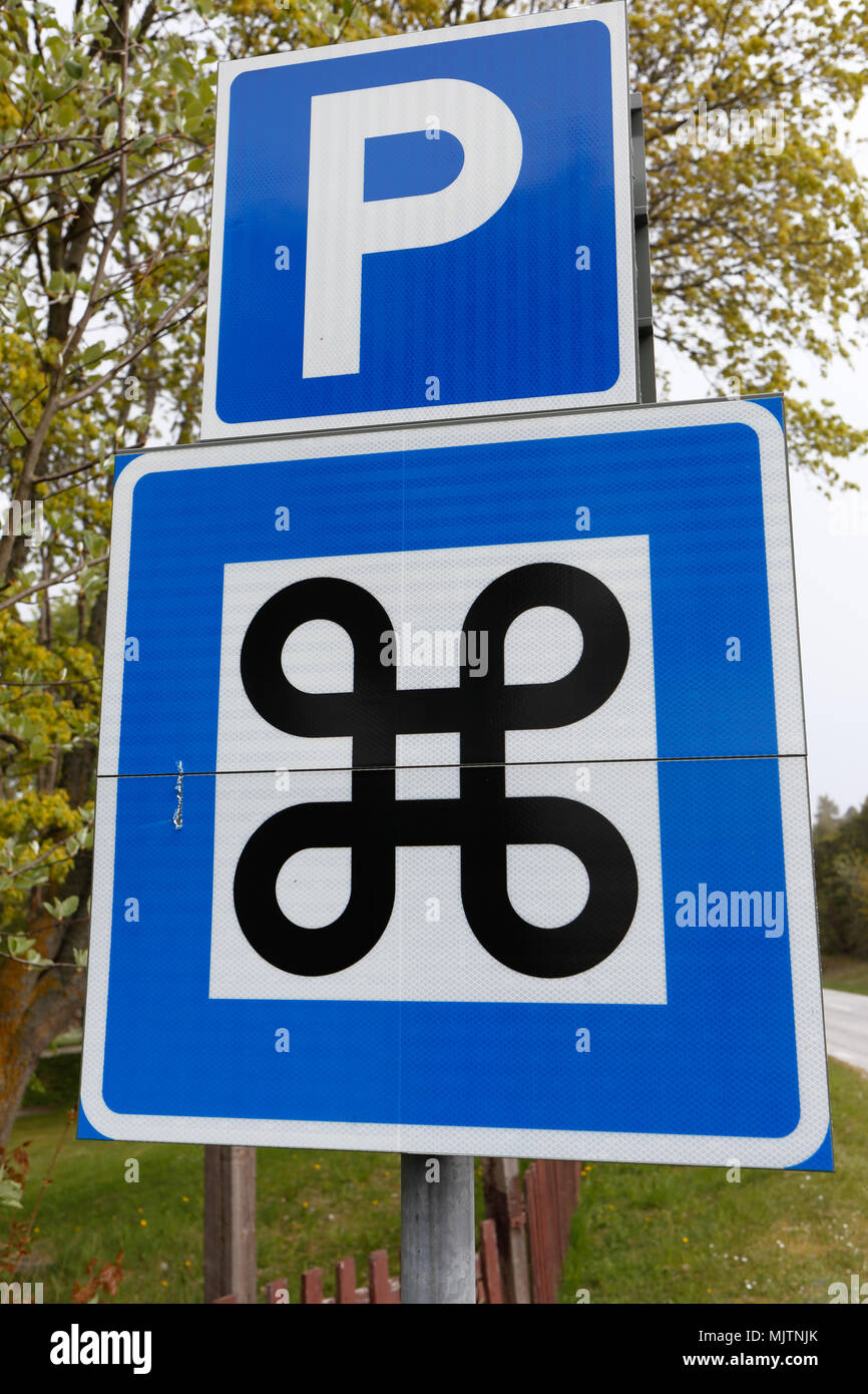 Signpost with Swedish road signs for car paring and national heritage ...