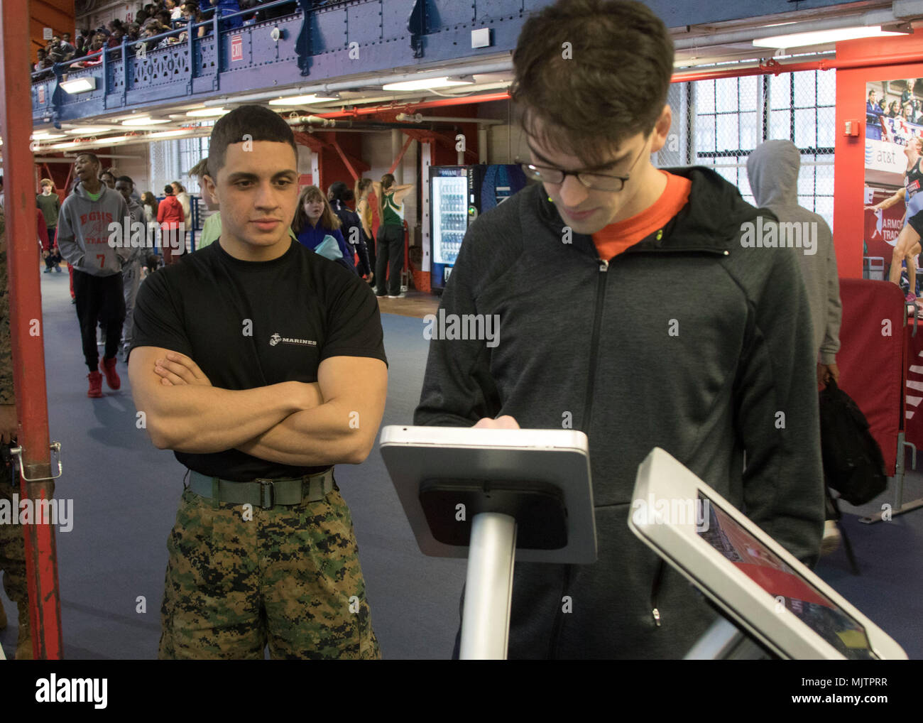 A U.S. Marine recruiter helps a high school student sign up for the ...