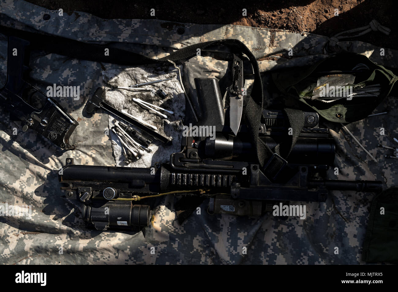 An M4 carbine sits on a poncho during Alligator Dagger in Djibouti ...
