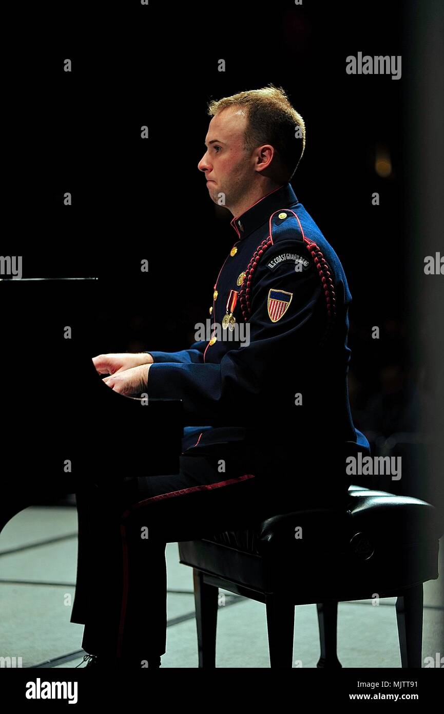 Petty Officer 1st Class Rob Lanslet performs on the piano during one of ...