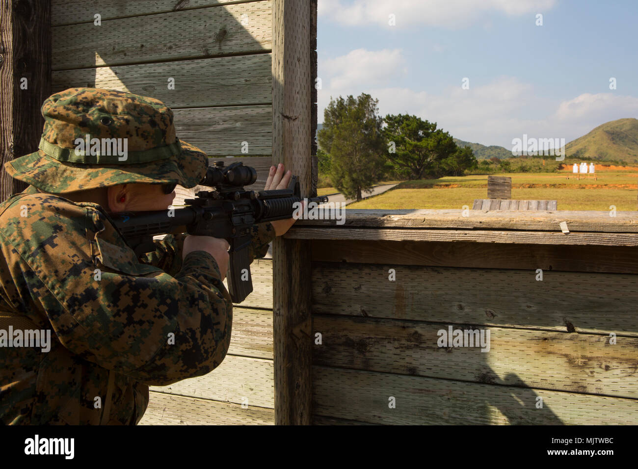 CAMP HANSEN, OKINAWA, Japan— A Marine fires his M16A4 service rifle ...