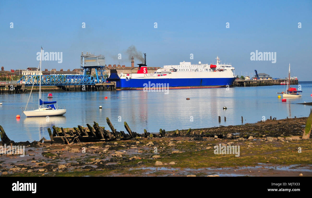 Blue sky view, from beach with wooden wreck at Knott End, across the ...