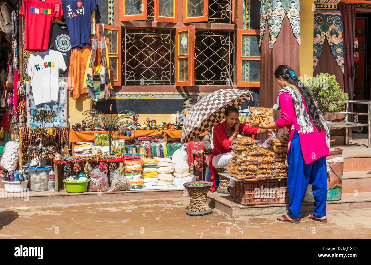 Shop keepers attending their premises on the streets of Boudhanath ...