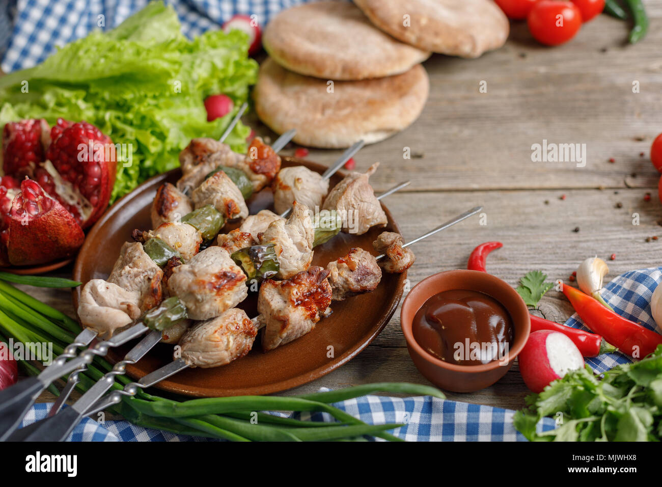 Shish kebab from pork on skewers laid out on a dish. Meat cooked on an ...