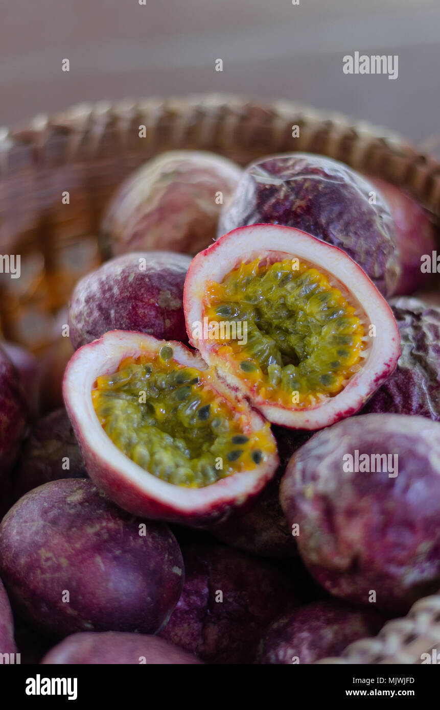 Passion fruit cut on the fruit basket Stock Photo - Alamy