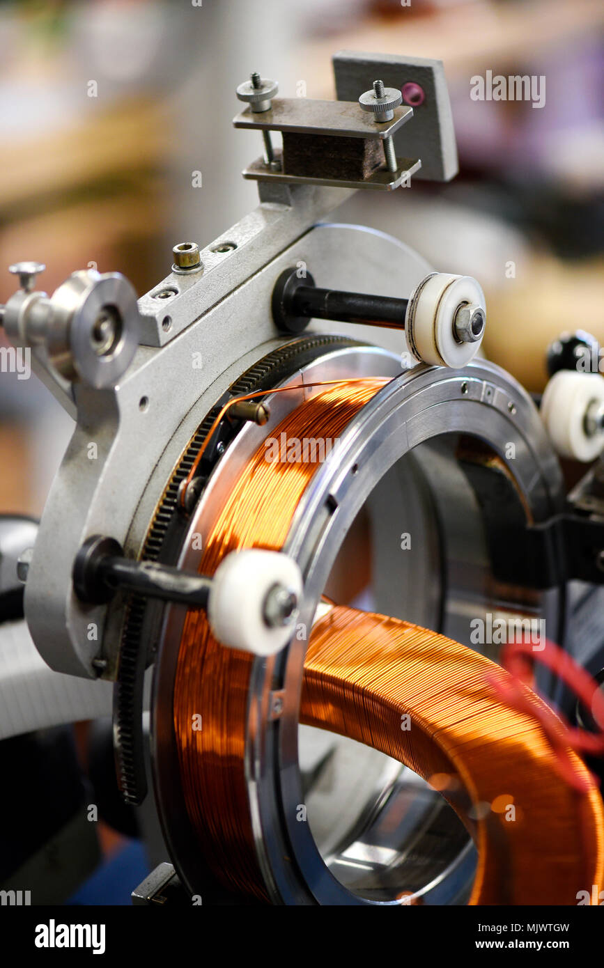 Electric transformers with copper wire at assembling line in close up ...