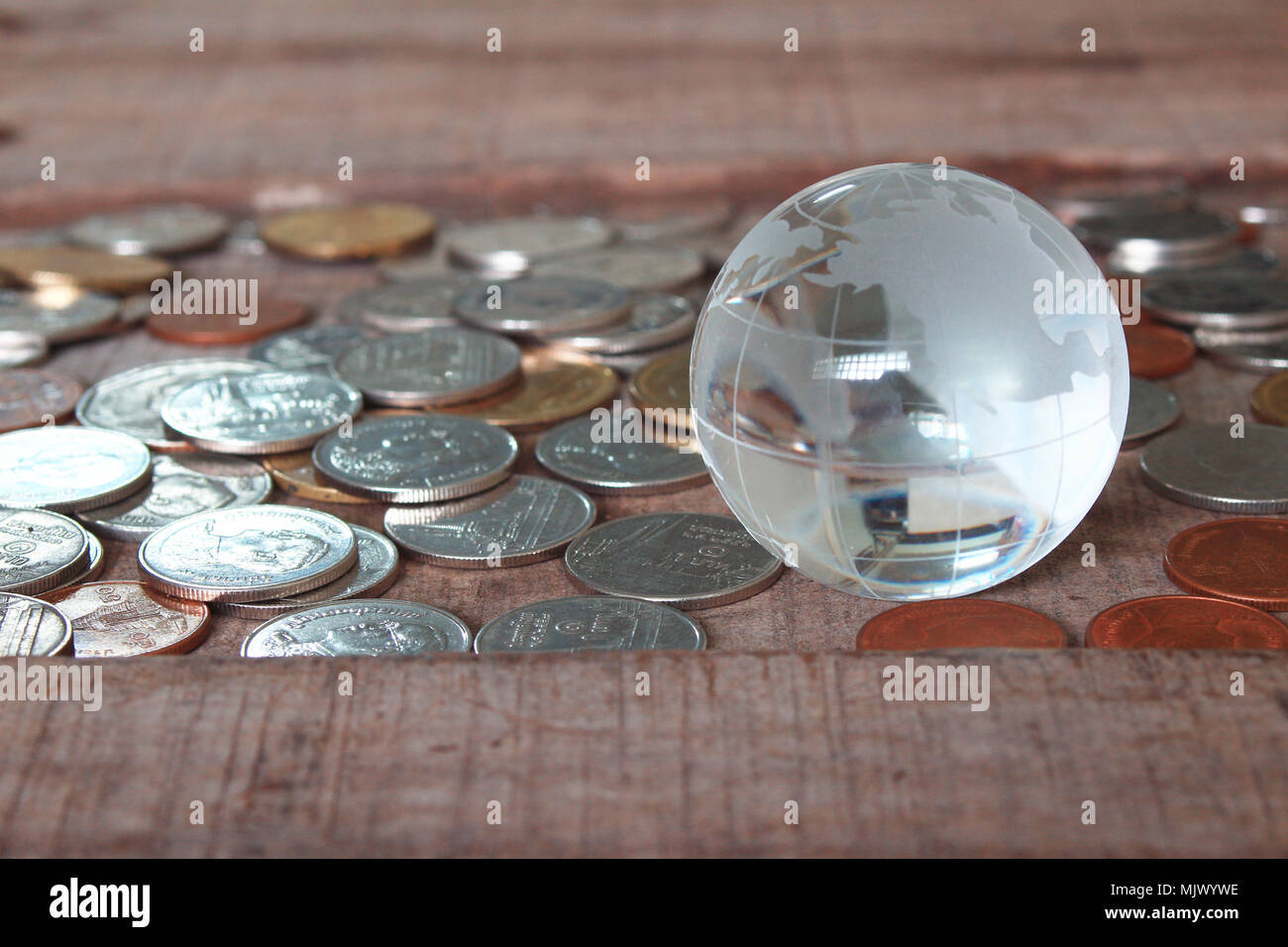 Map world glass on coins , finicial concept Stock Photo - Alamy