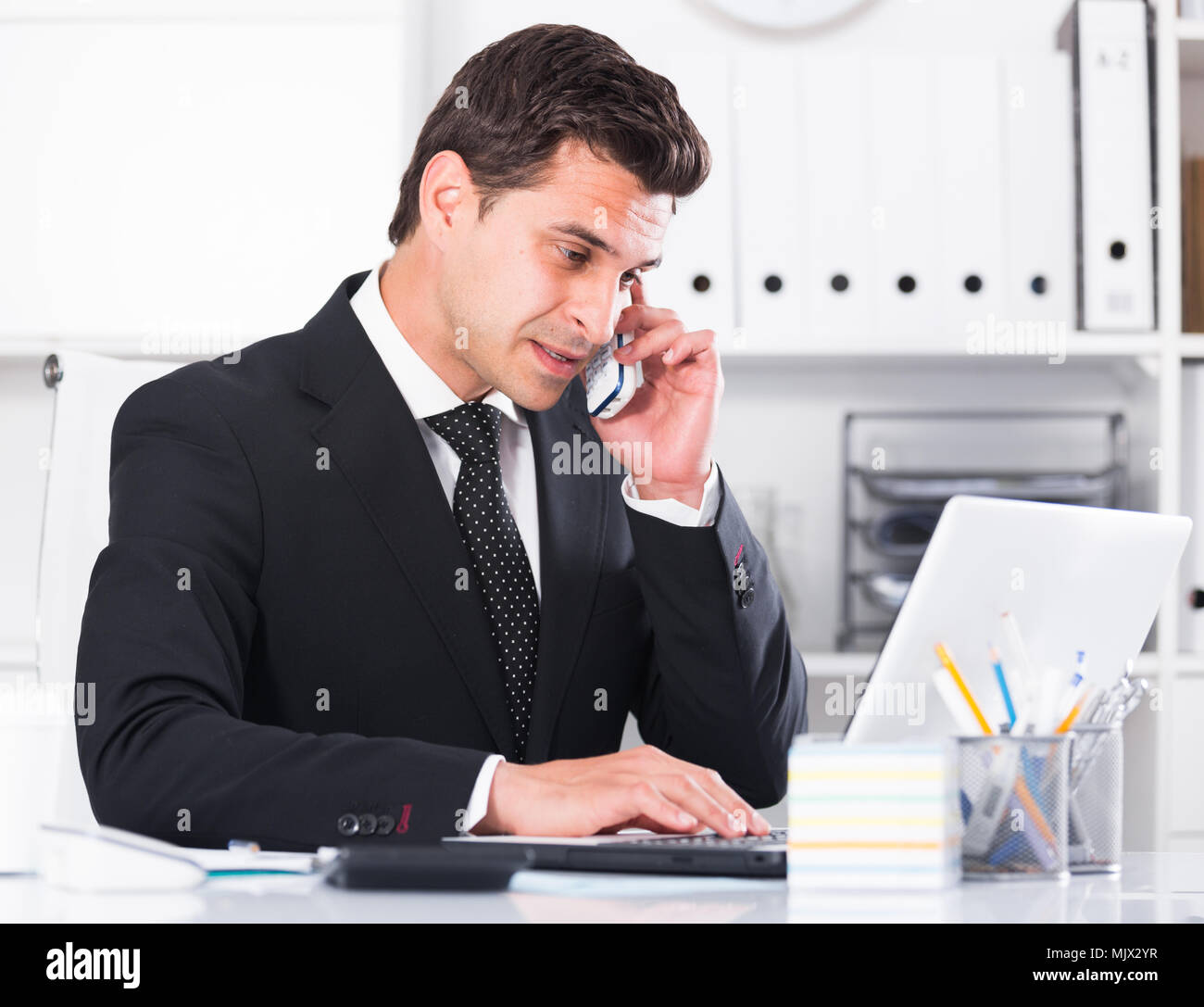 Businessman having phone call conversation at workplace in office Stock ...