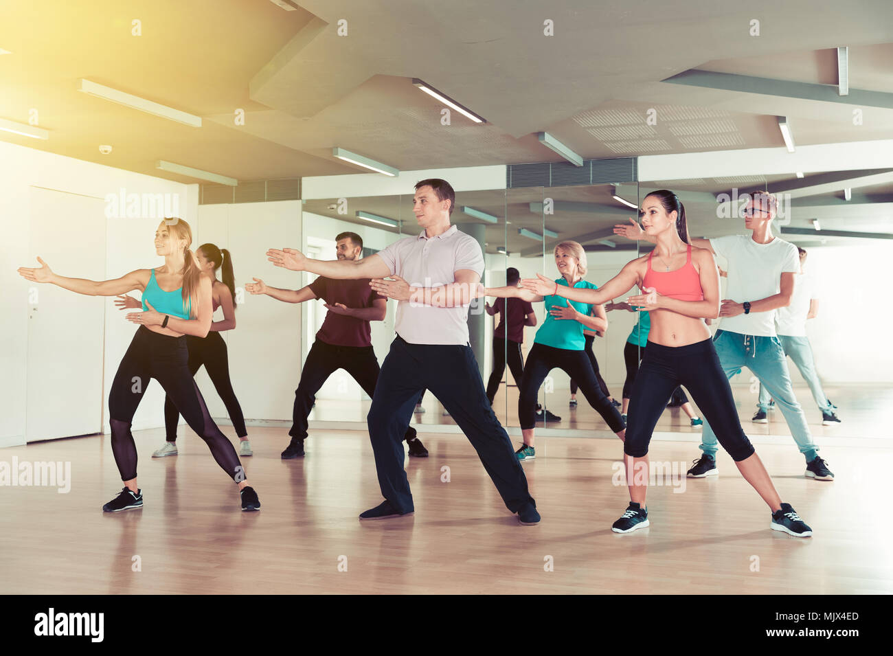 Happy different ages adults training swing steps at dance class Stock ...